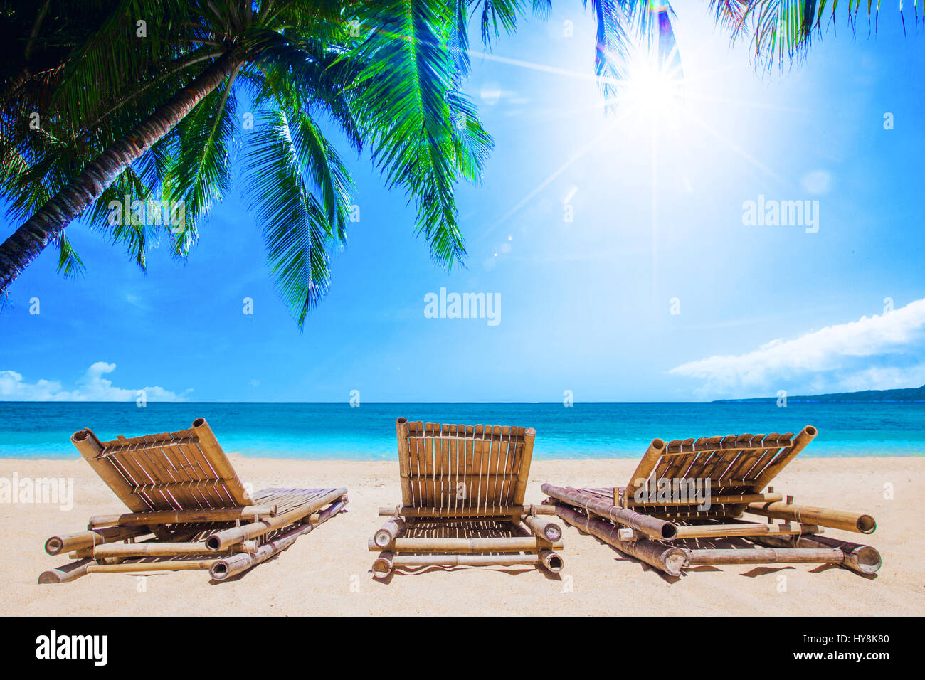 Beach beds under the palm trees on tropical beach, summer vacantion ...