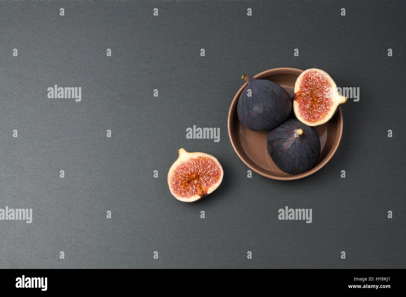 Top view of fresh figs on dark slate stone background Stock Photo - Alamy