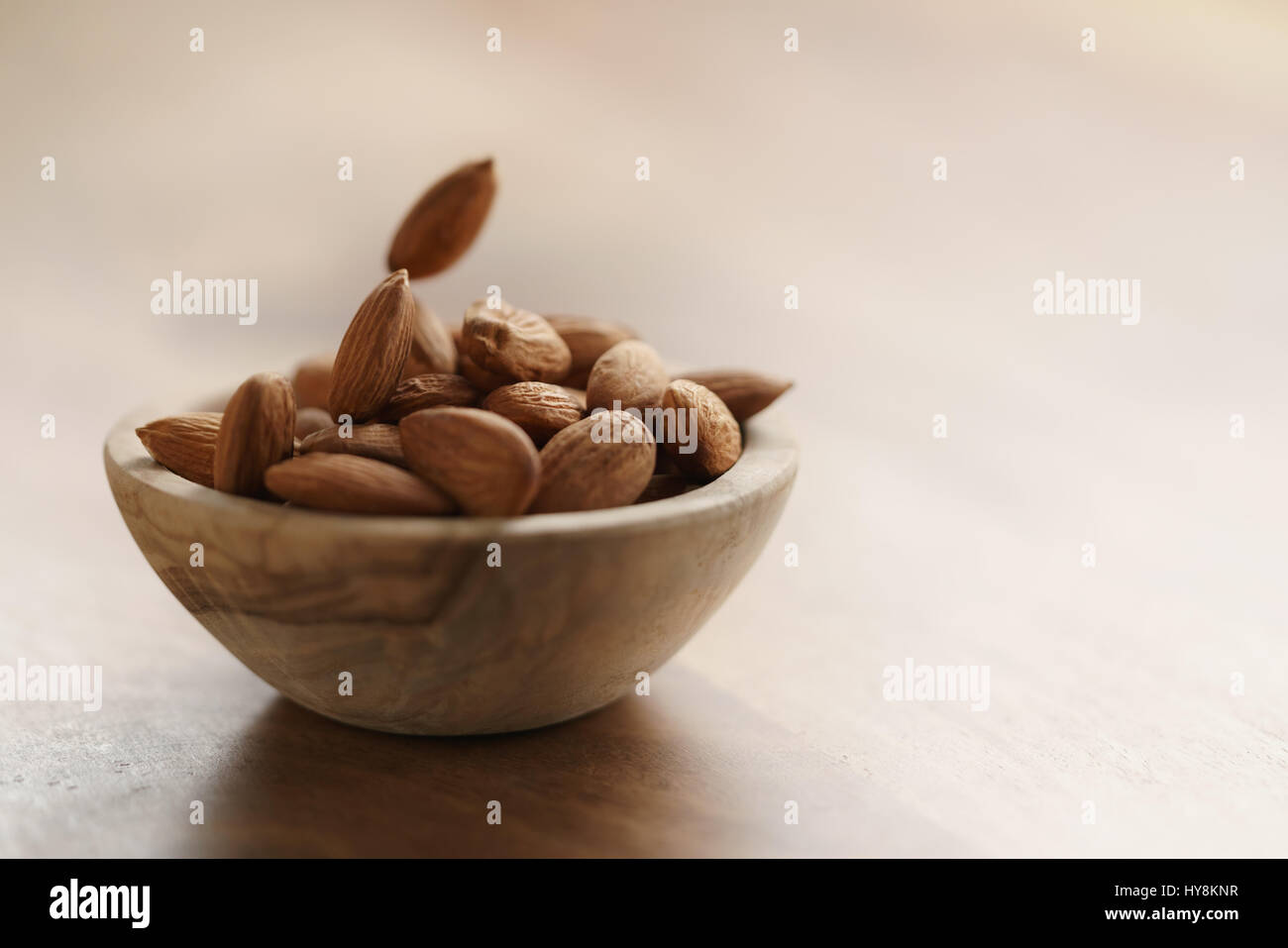 Roasted almonds falling in wooden hi-res stock photography and images ...