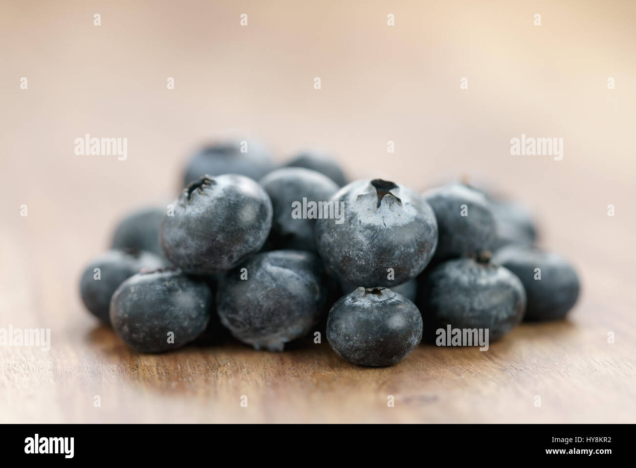heap of fresh garden blueberries on wood table, closeup photo Stock ...
