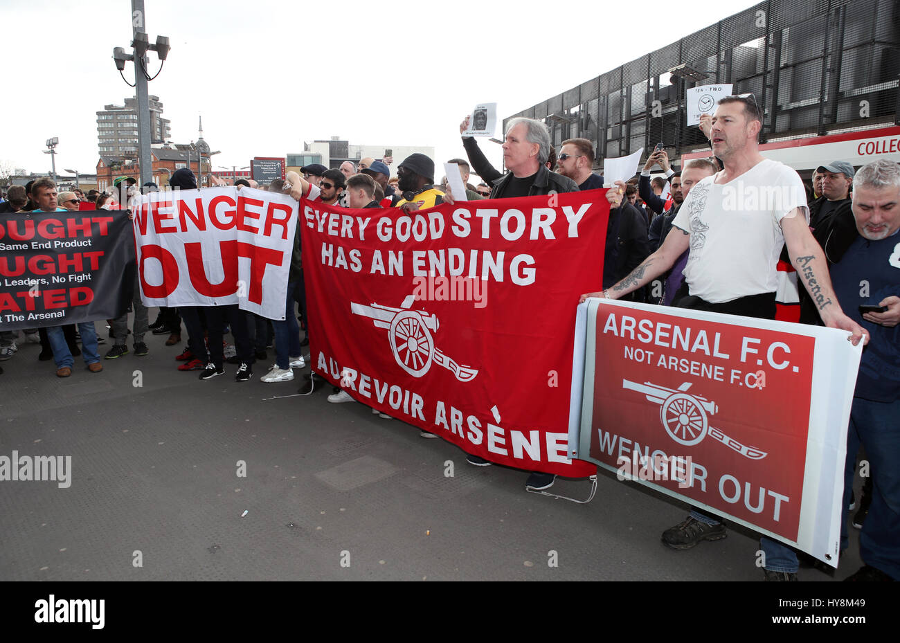 Arsenal fans hold up banners in protest against manager Arsene Wenger ...