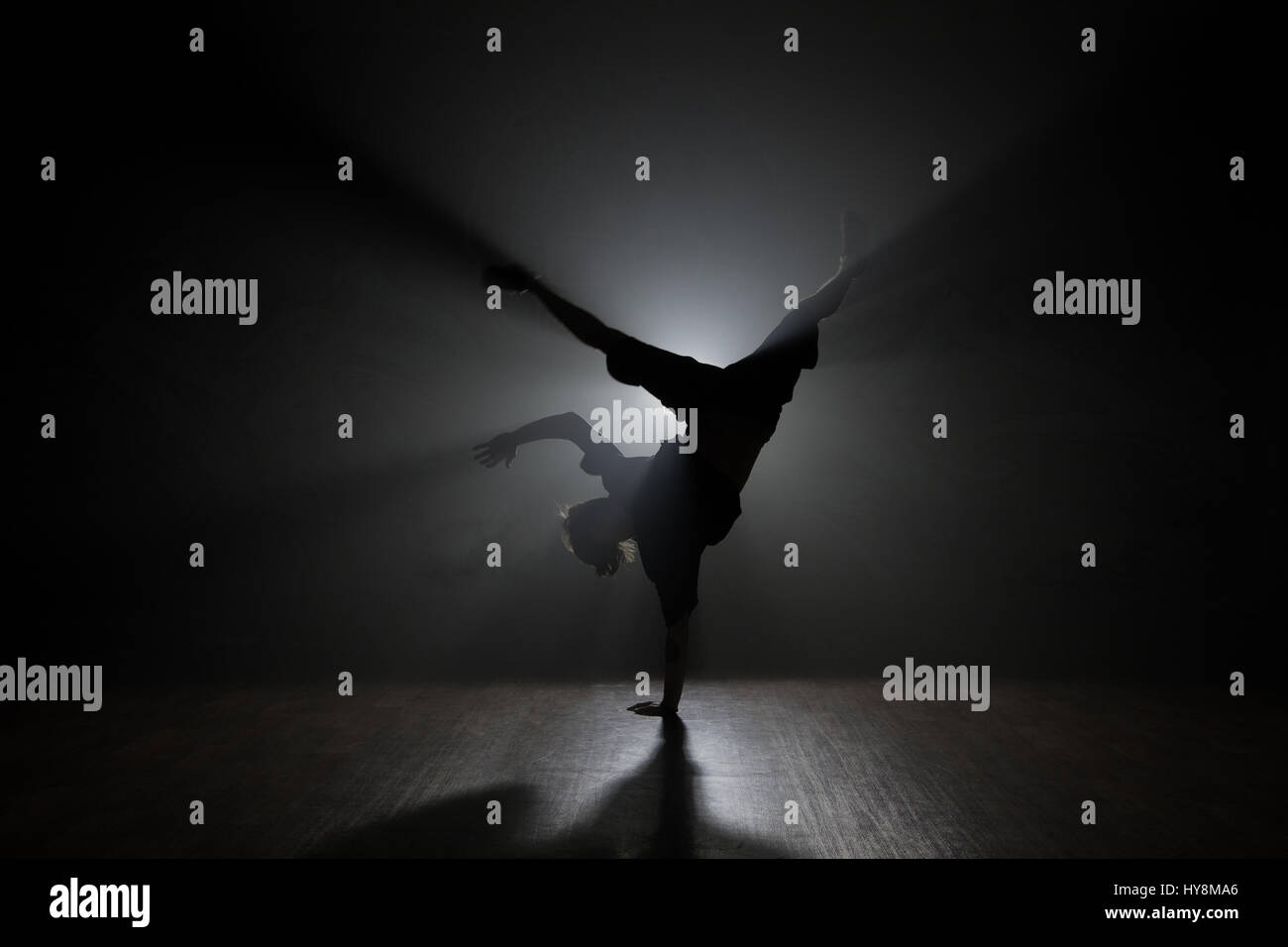 Hip-hop dancer posing backlit Stock Photo - Alamy