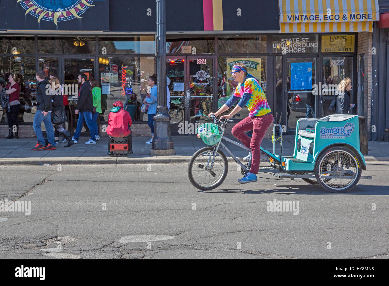 Ann Arbor, Michigan - A pedicab driver looks for passengers on a busy ...