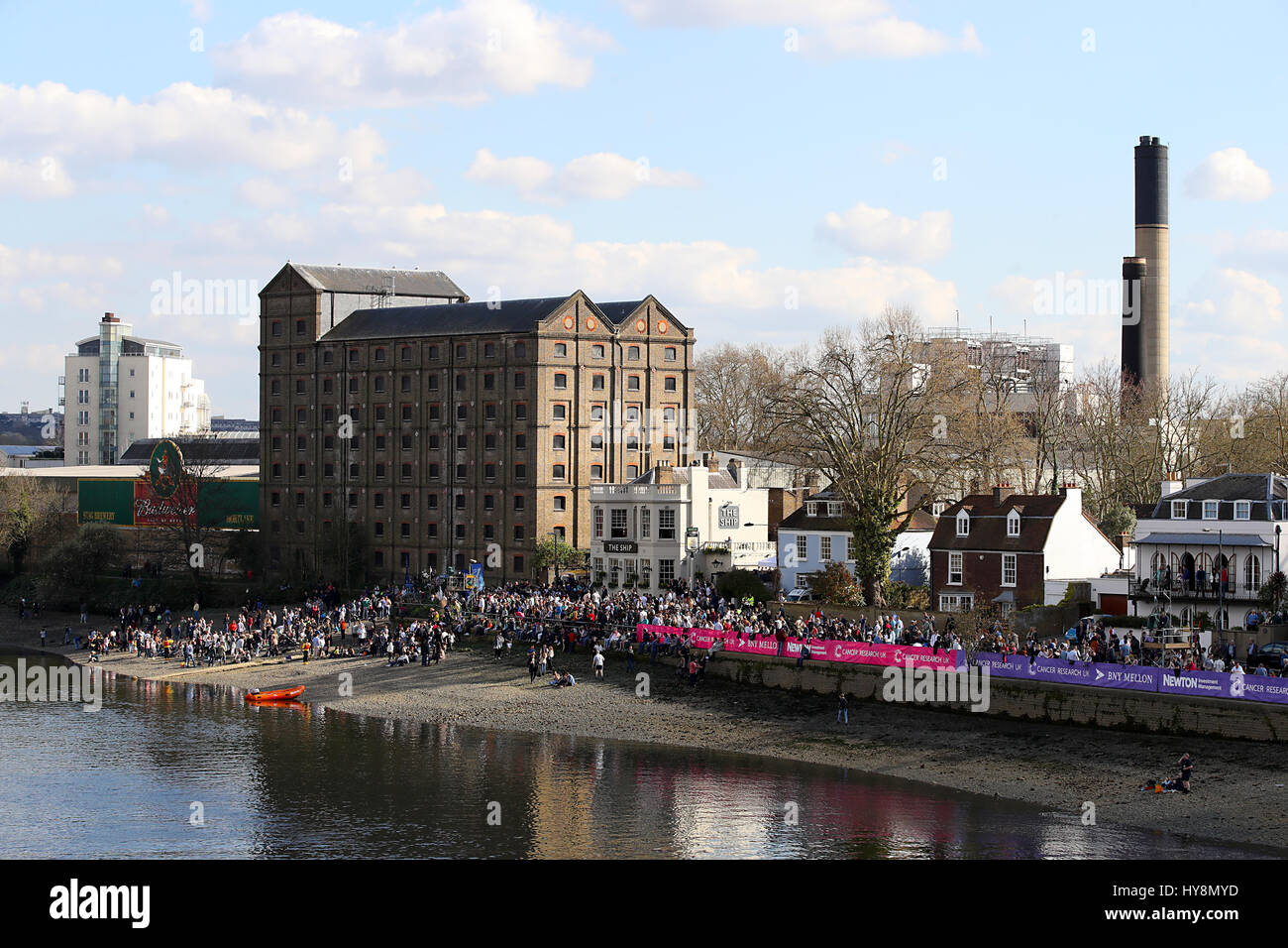 Spectators on the riverbank close to Chiswick Bridge prior to the Men's ...