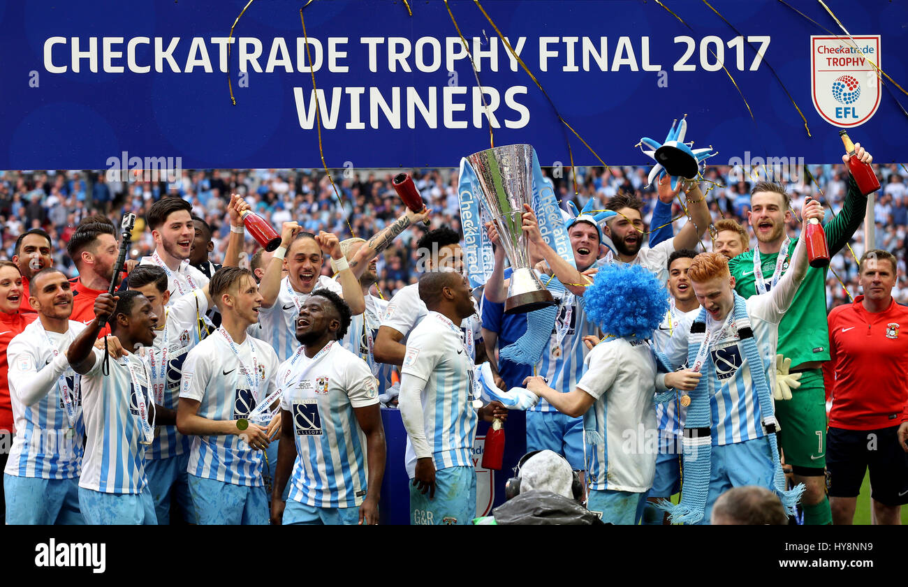 Coventry City players celebrate as Chris Stokes lifts the trophy after ...