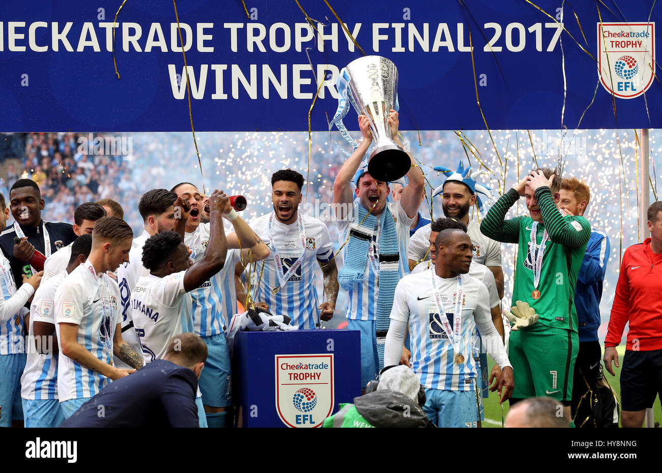 Coventry City players celebrate as Chris Stokes lifts the trophy after ...