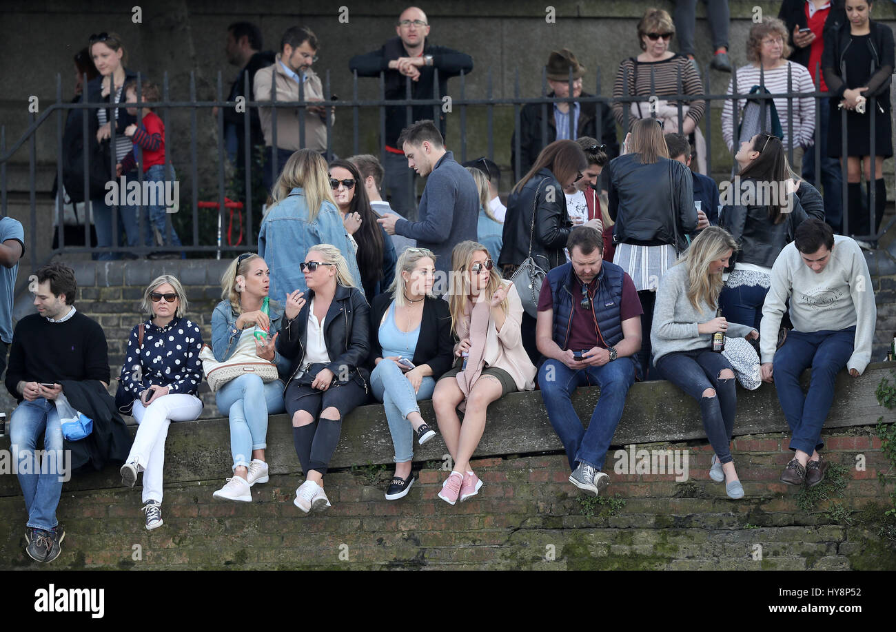 Spectators gather to watch the Men's Boat Race on the River Thames ...