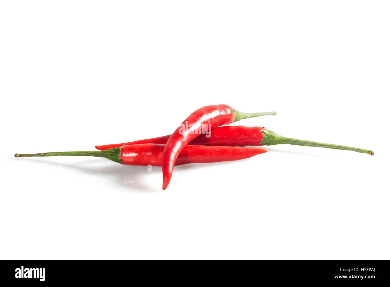 Three red chili peppers isolated on white background Stock Photo - Alamy