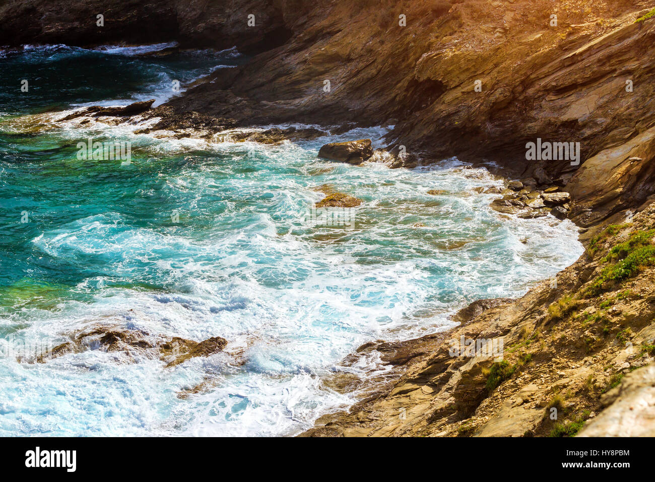 Waves break on rocky shore. Raging sea an elemental power in a storm ...