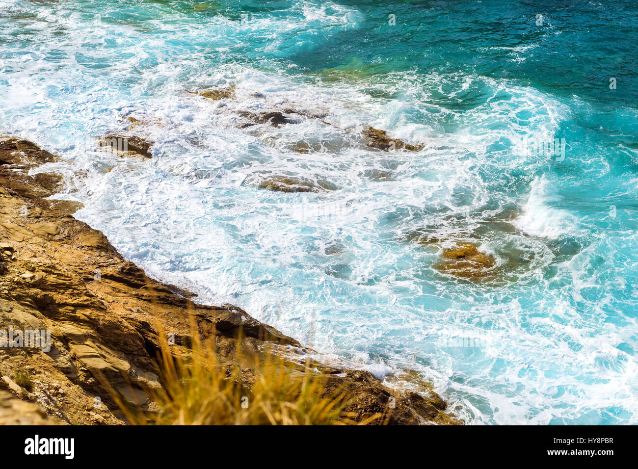 Waves break on rocky shore. Raging sea an elemental power in a storm ...