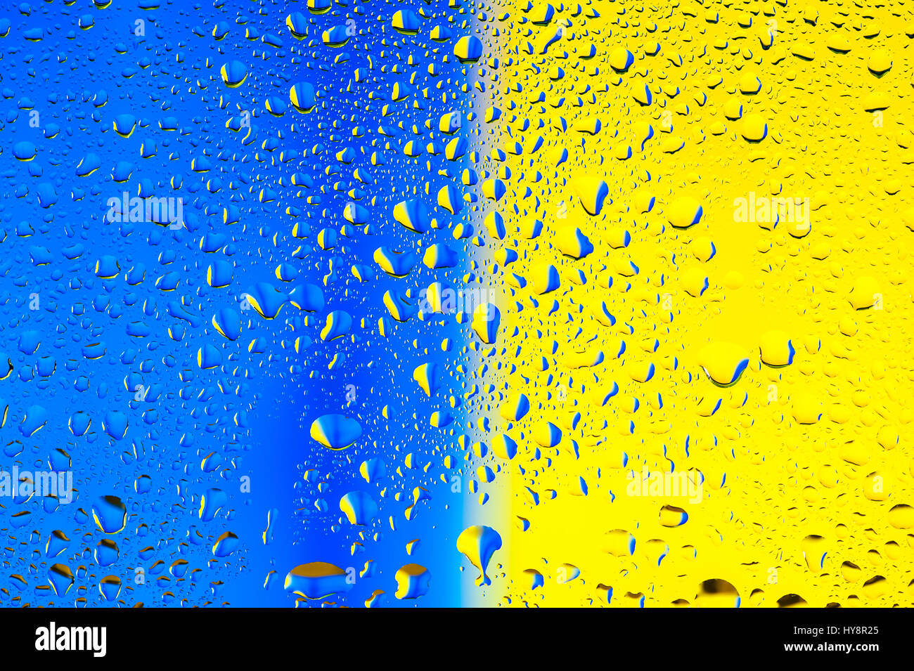 Abstract texture - Water drops on glass with blue and yellow background ...