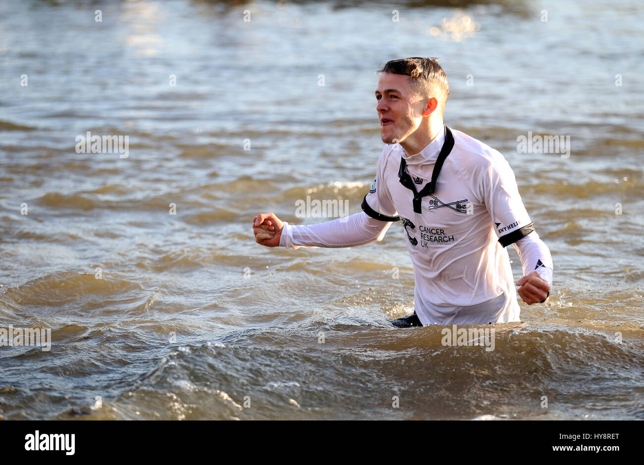 Oxford's cox Sam Collier celebrates after being thrown into the river ...
