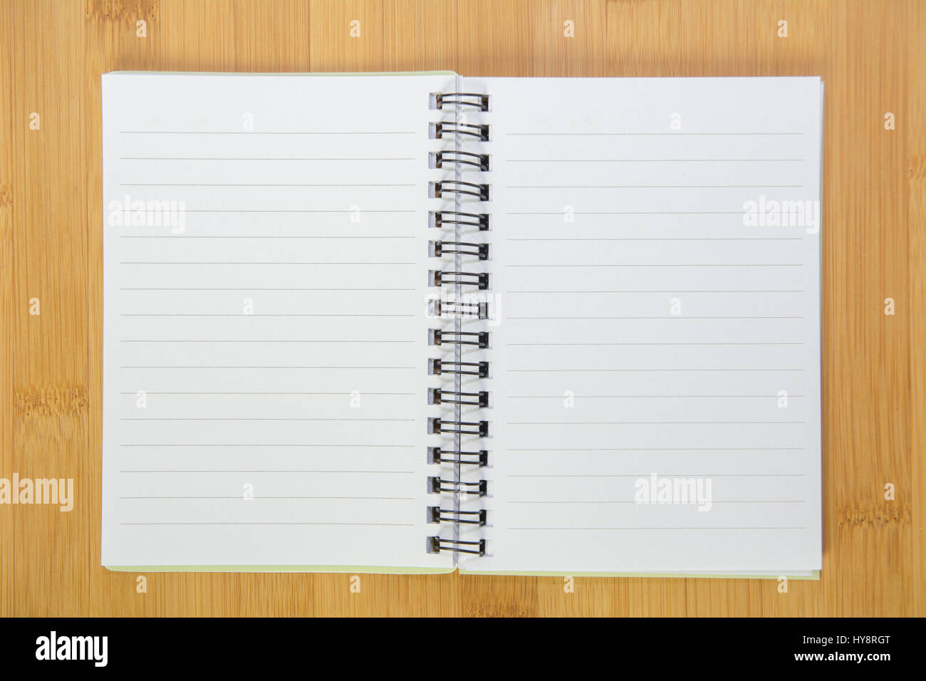 Opening white paper book on wooden table Stock Photo - Alamy