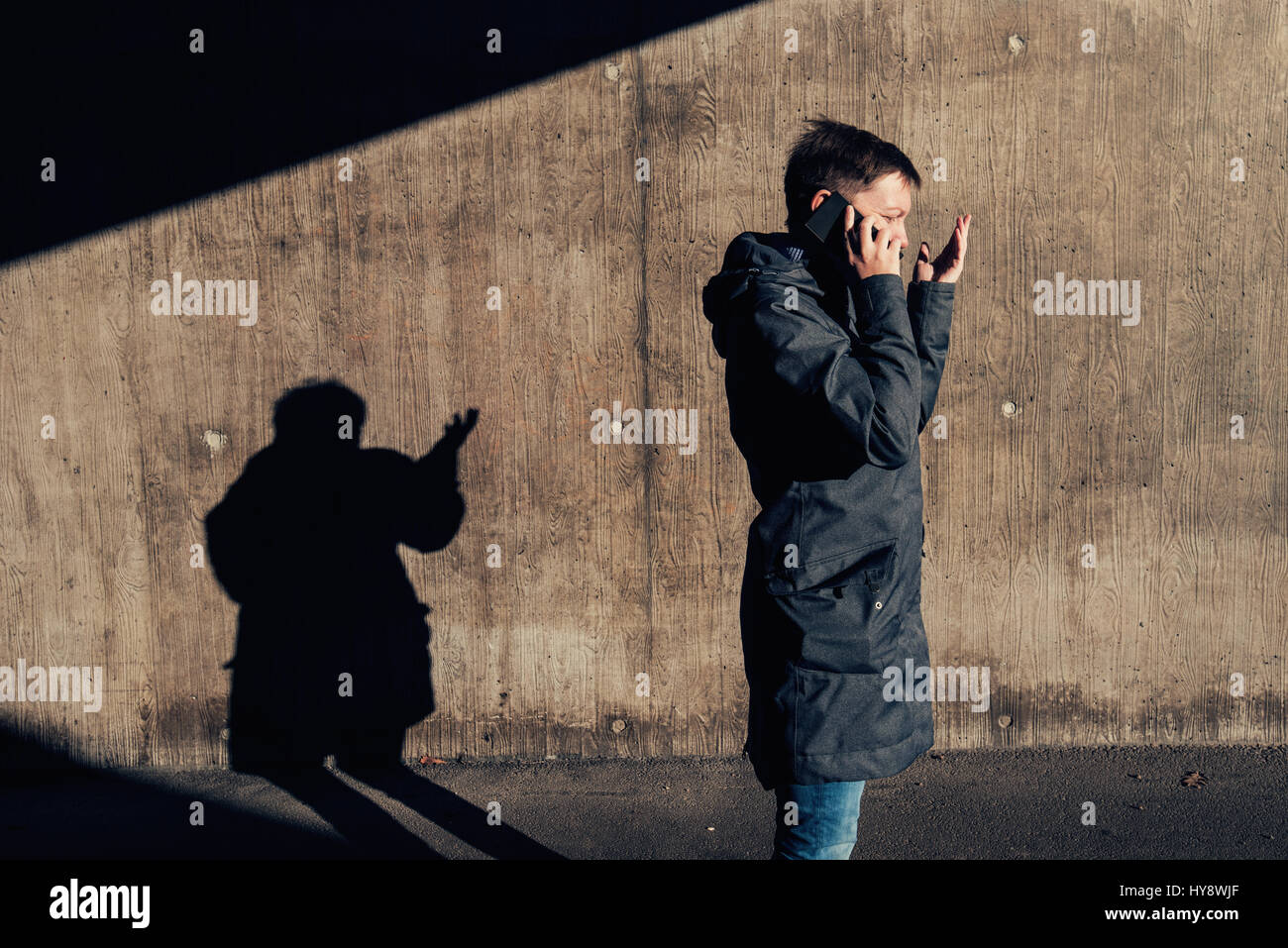 Serious authentic woman with short hair talking on mobile phone on the ...