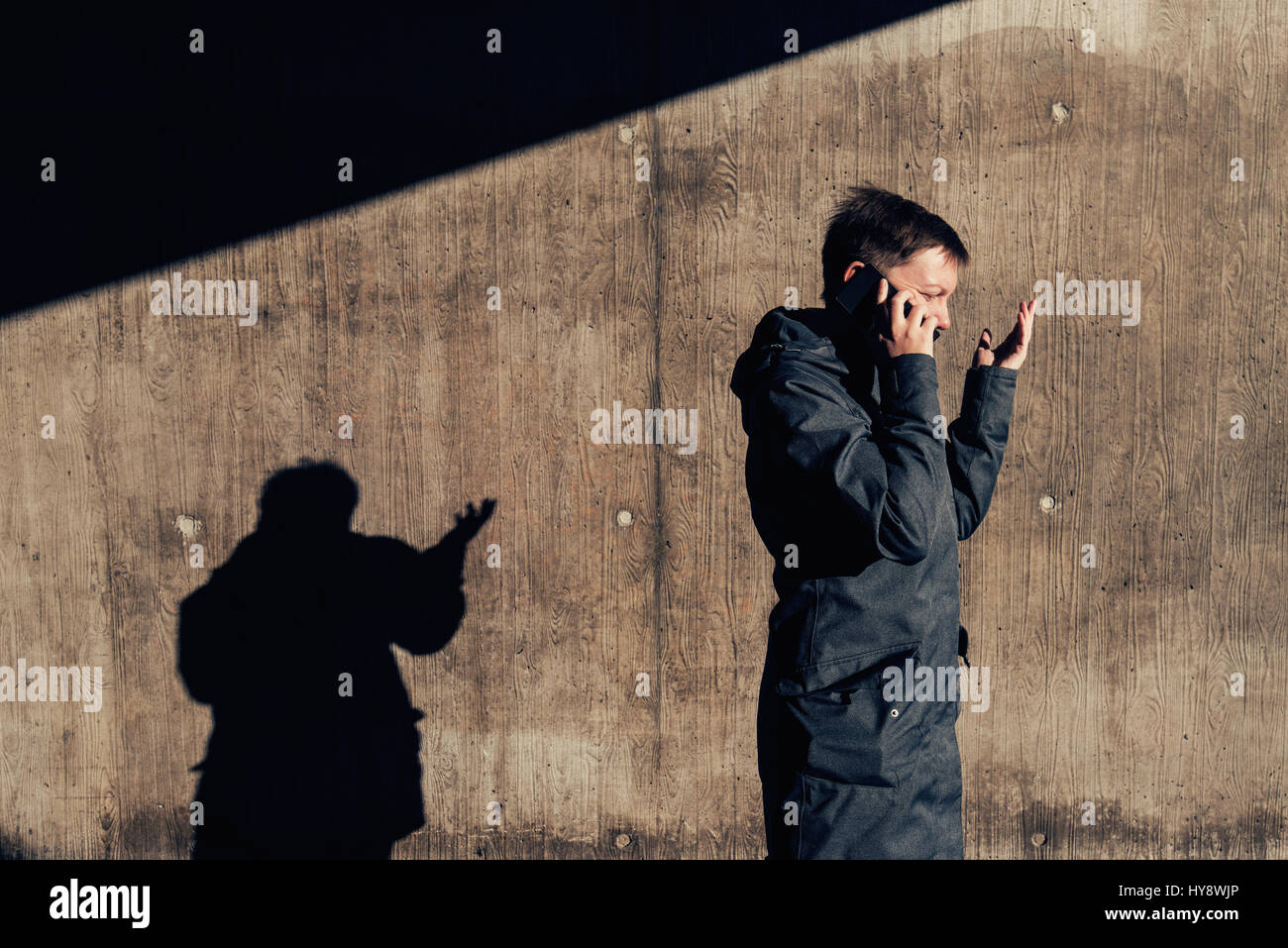Serious authentic woman with short hair talking on mobile phone on the ...