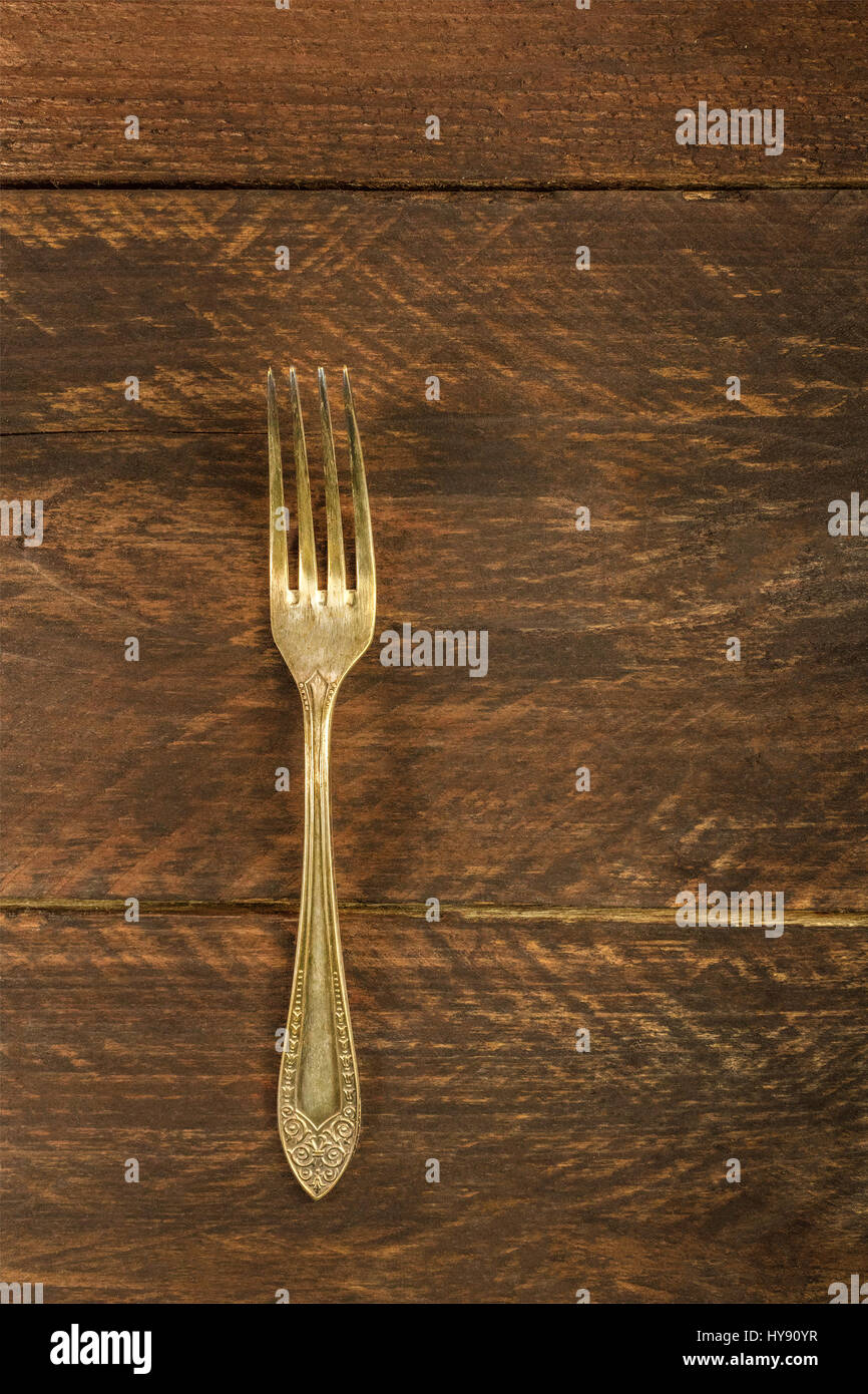 Vintage fork on wooden background with copyspace Stock Photo - Alamy