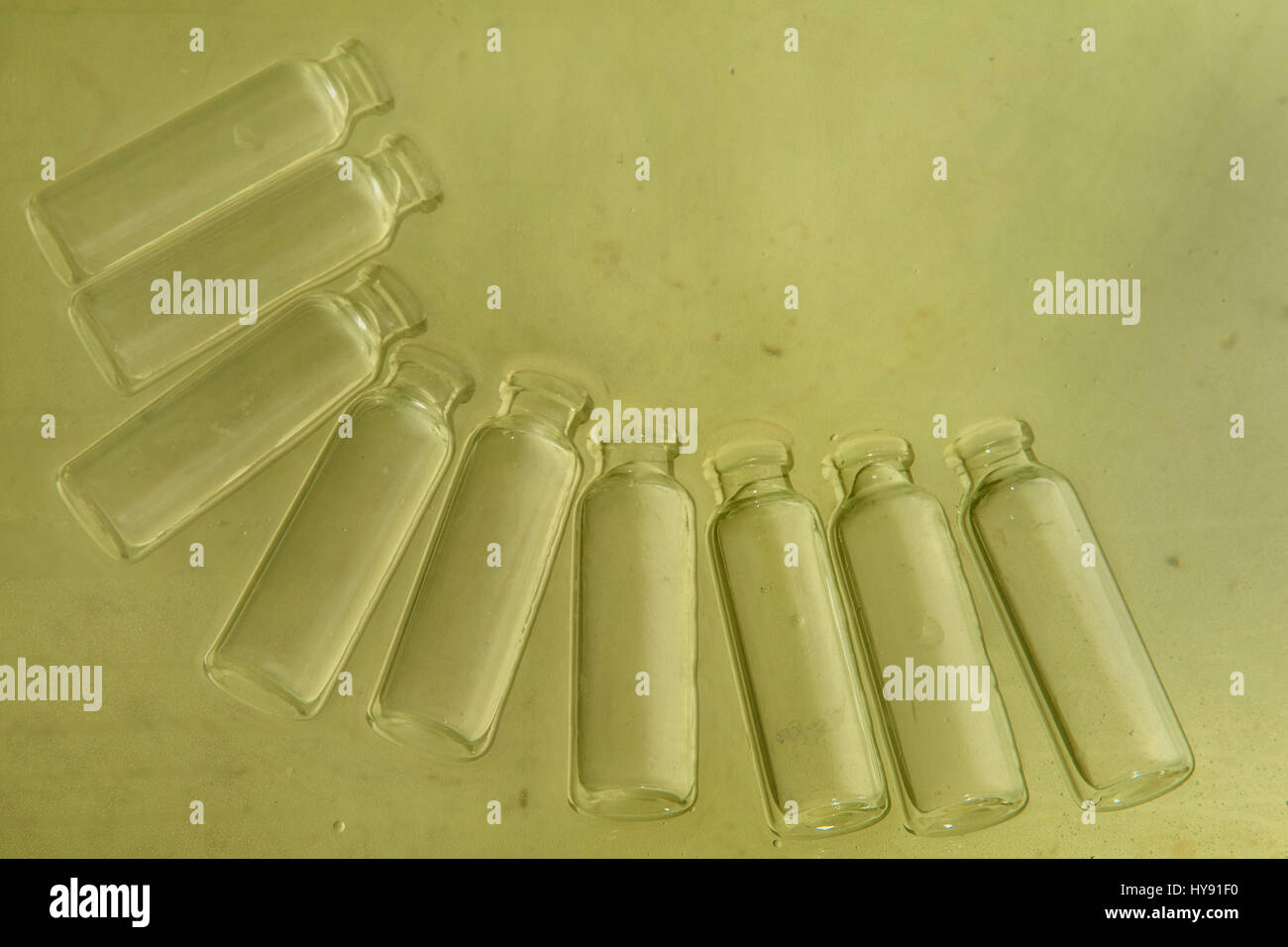 Green background old paper with a large empty glass antique bottles ...