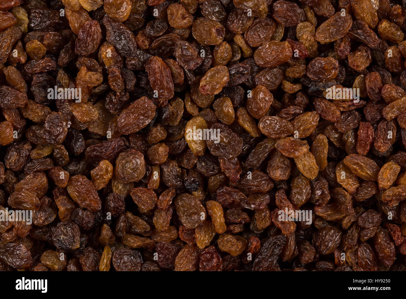 Sweet dry raisins close up shot for background Stock Photo - Alamy