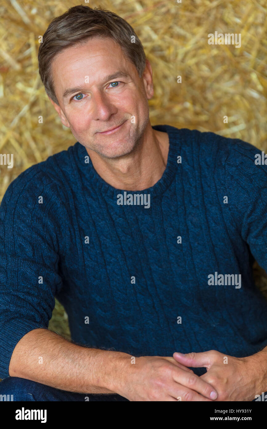 Portrait shot of an attractive, successful and happy middle aged man ...