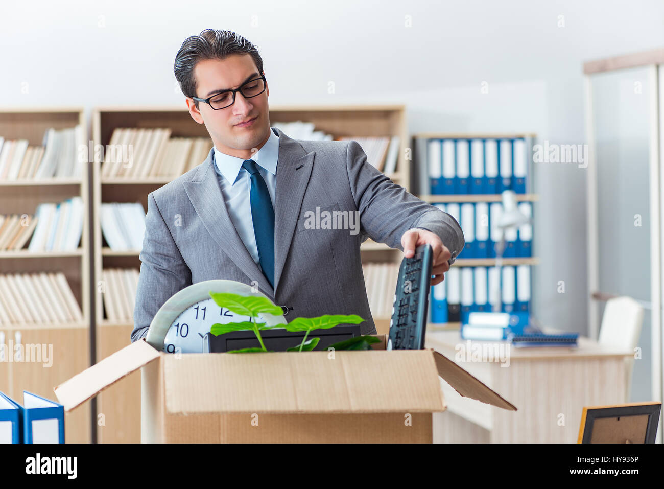 Man moving office with box and his belongings Stock Photo - Alamy