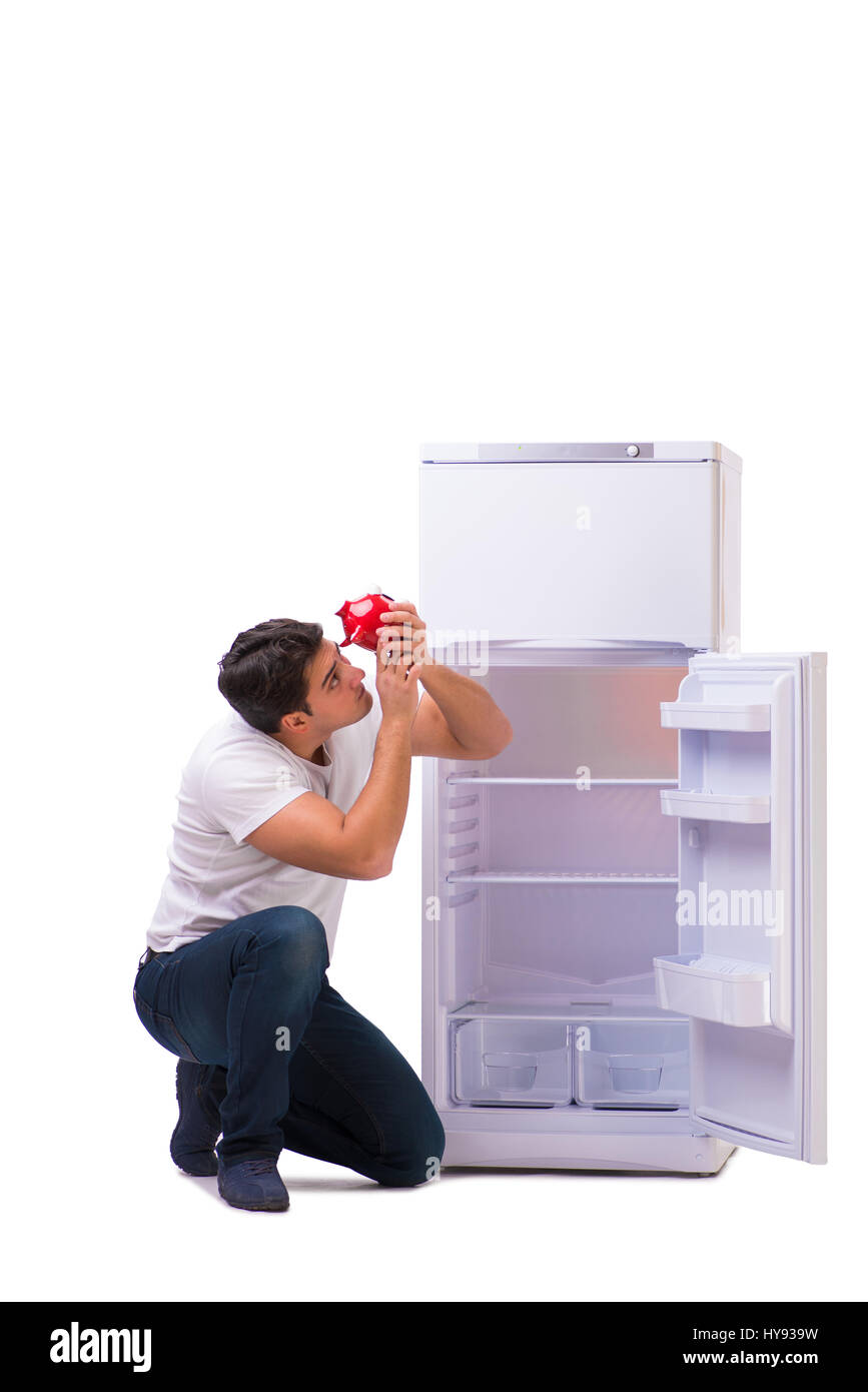 Hungry man looking for money to fill the fridge Stock Photo - Alamy