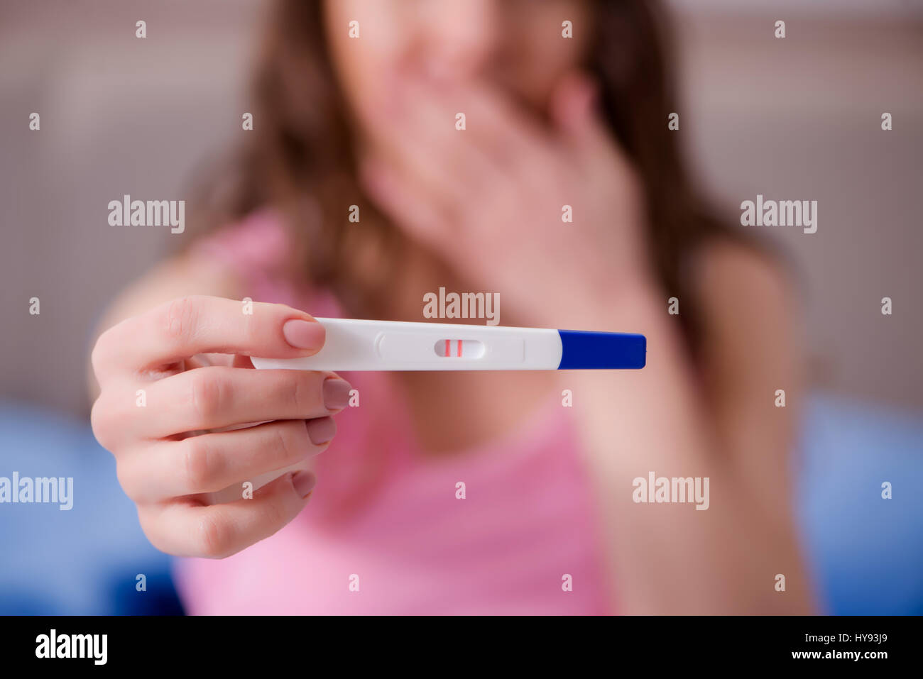 Woman discovering her positive pregnancy test Stock Photo - Alamy