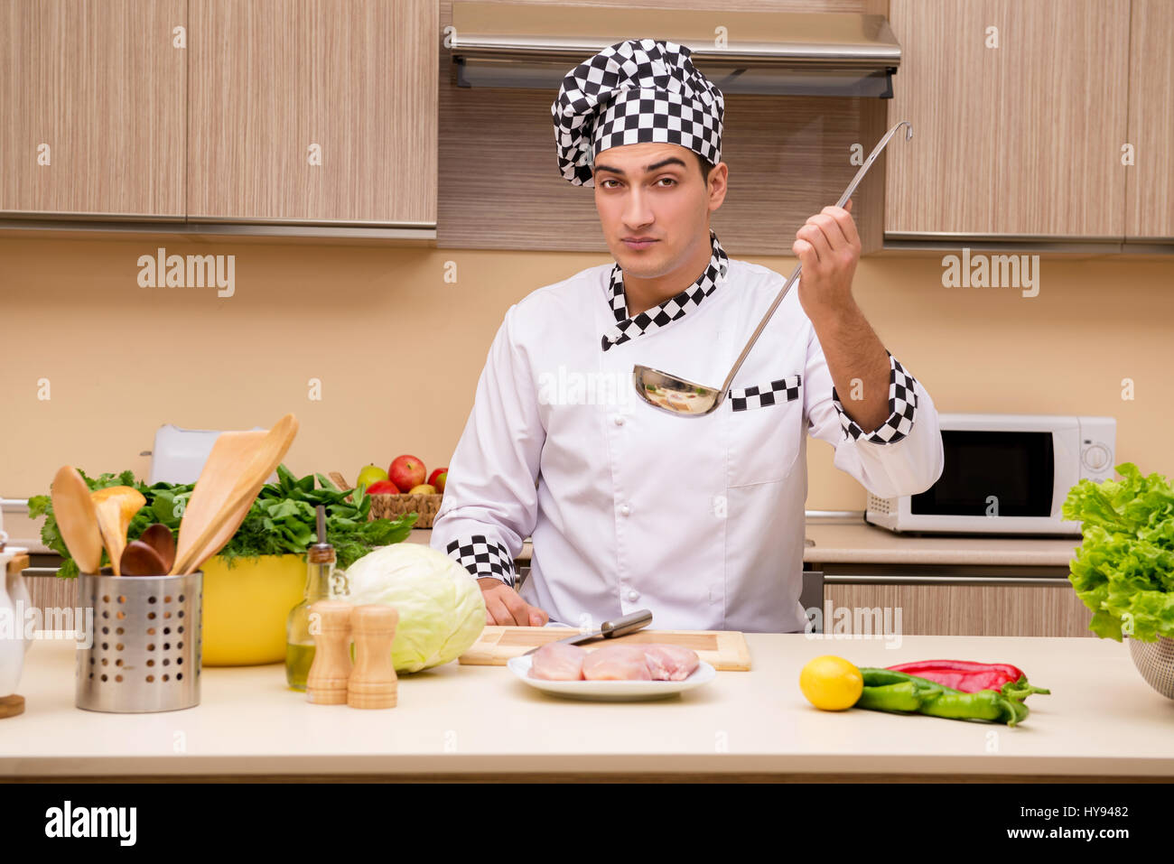 Young chef working in the kitchen Stock Photo - Alamy