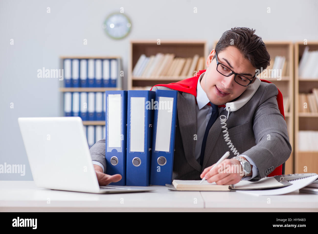 Superhero businessman working in the office Stock Photo - Alamy