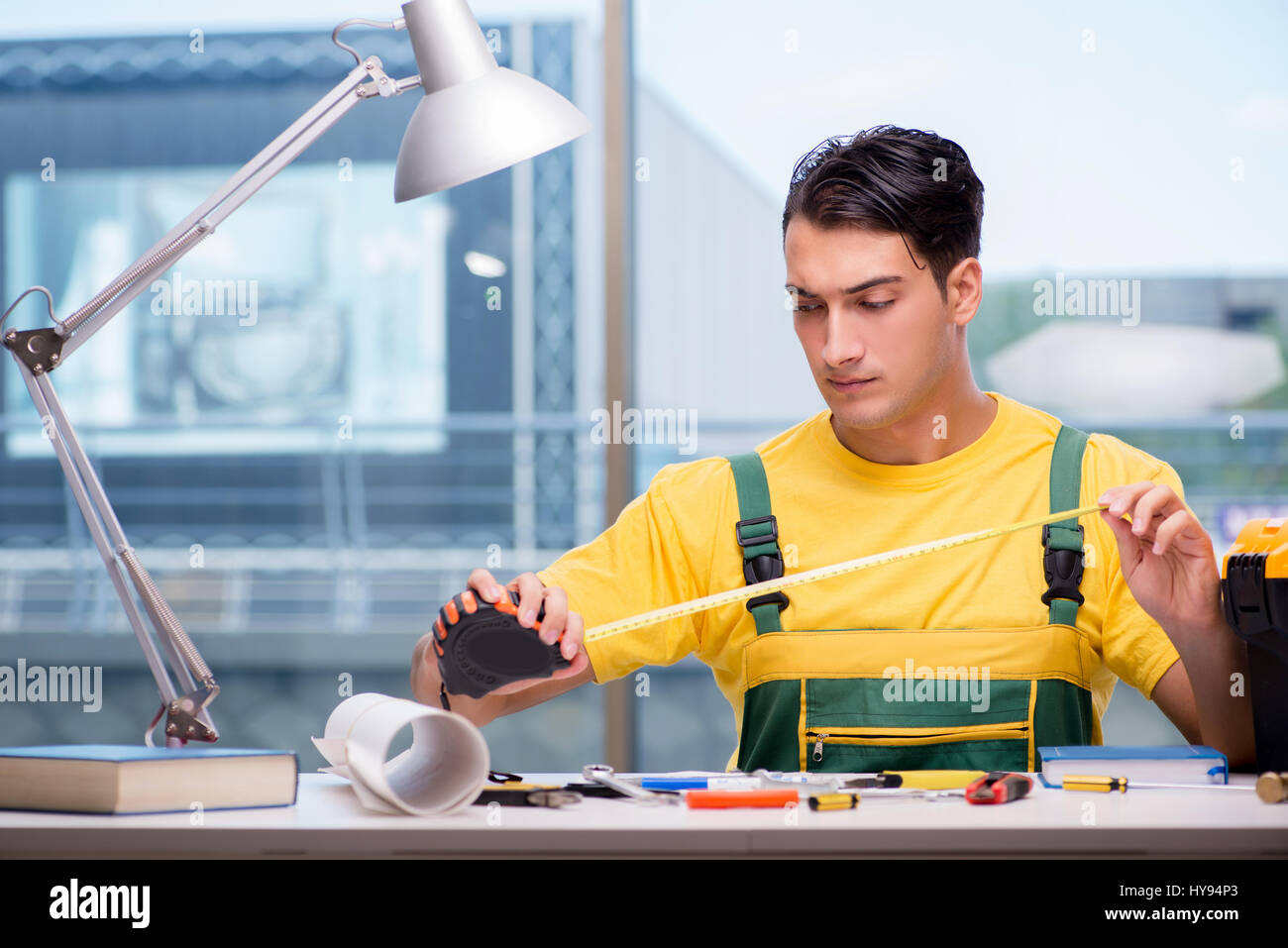 Construction worker sitting at the desk Stock Photo - Alamy