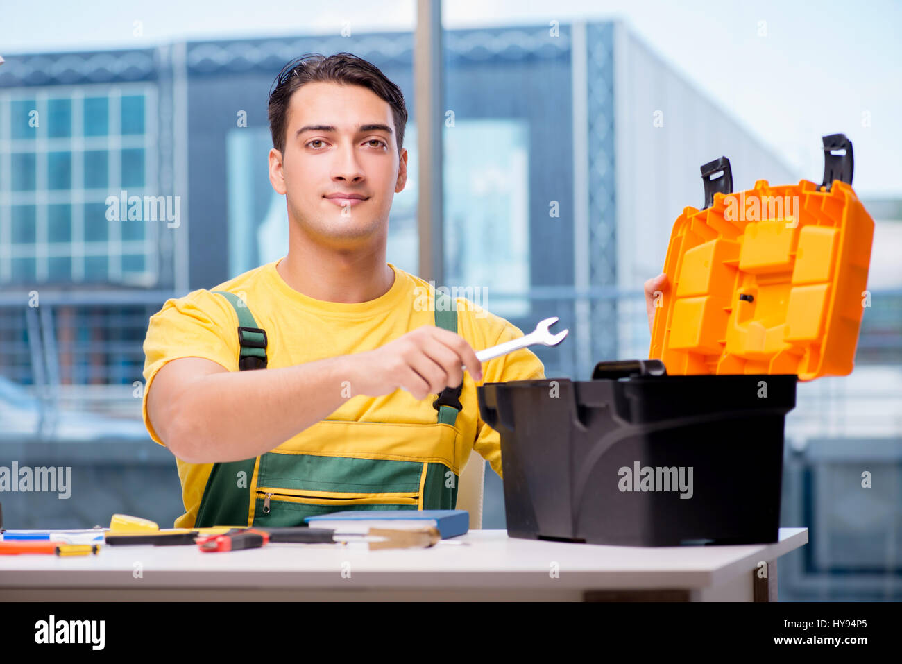 Construction worker sitting at the desk Stock Photo - Alamy