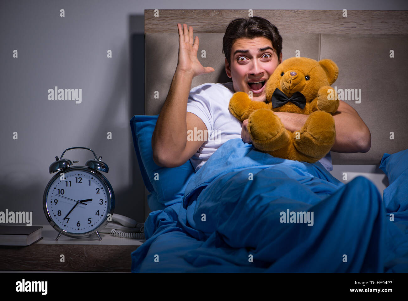 Young man scared in bed Stock Photo - Alamy