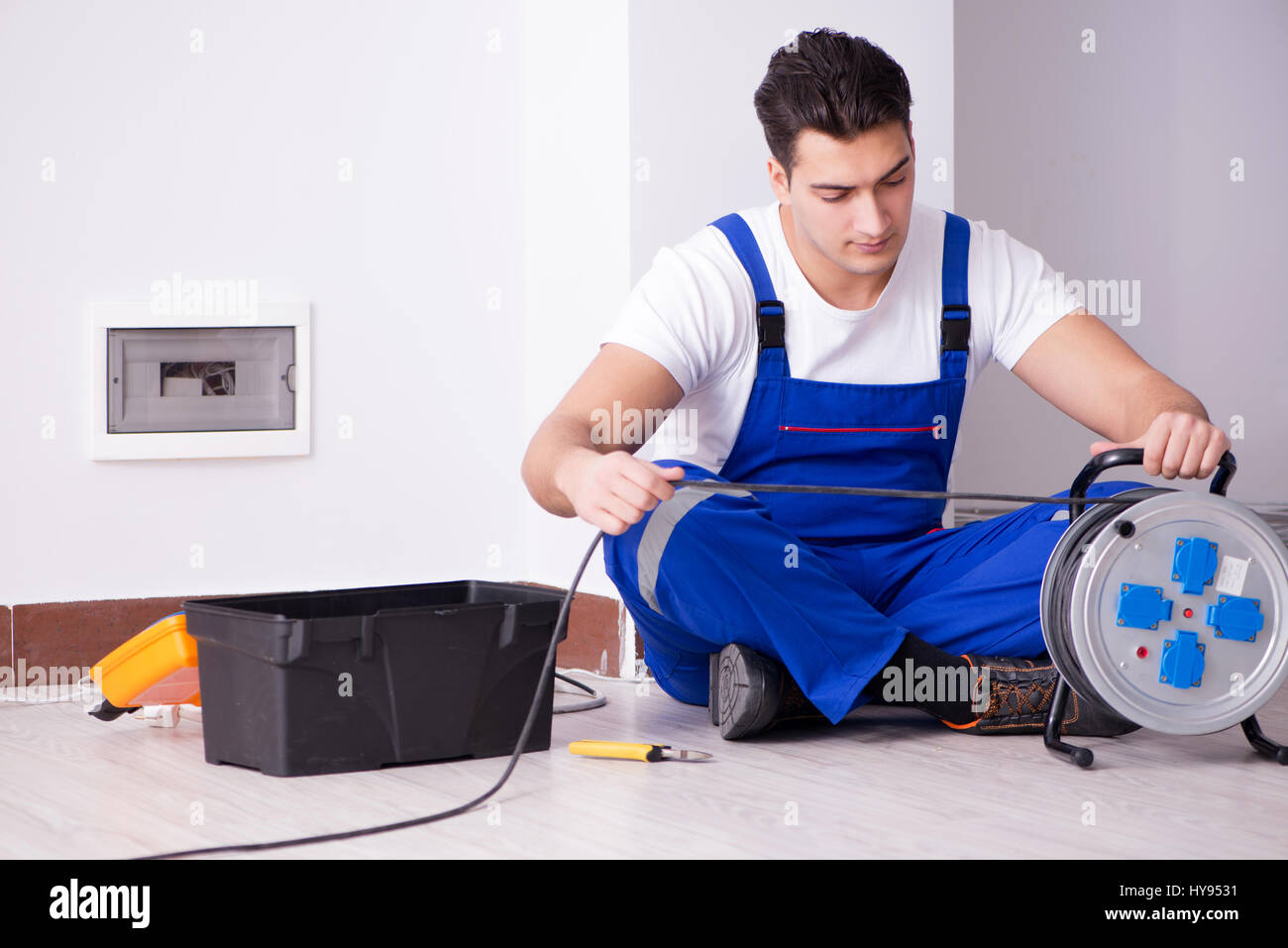 Young electrician working on socket at home Stock Photo - Alamy