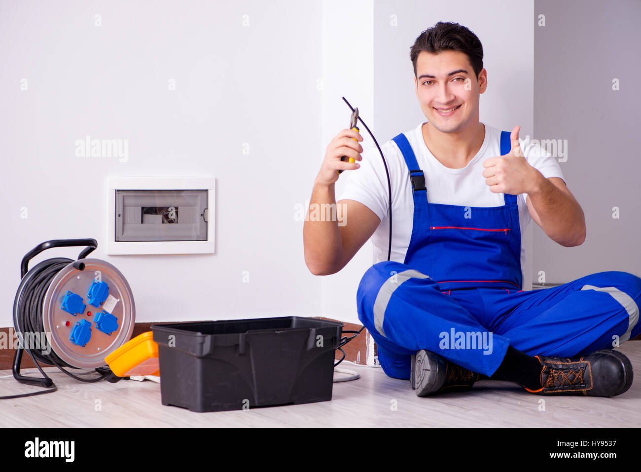 Man doing electrical repairs at home Stock Photo - Alamy