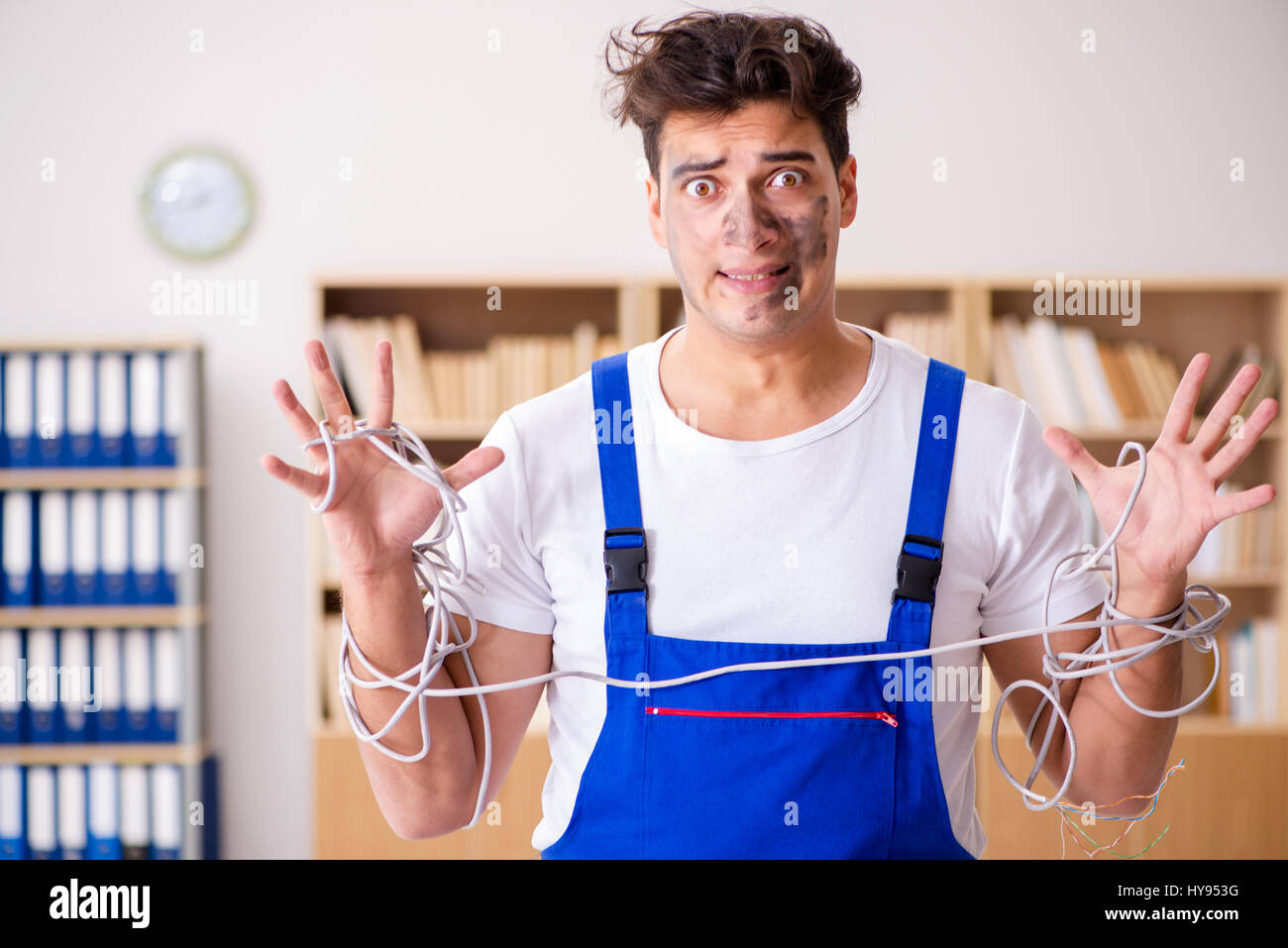 Funny Man doing electrical repairs at home Stock Photo - Alamy