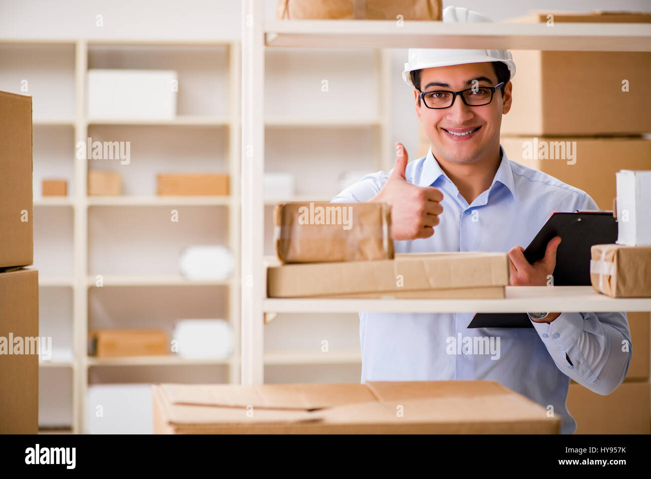 Man working in postal parcel delivery service office Stock Photo - Alamy