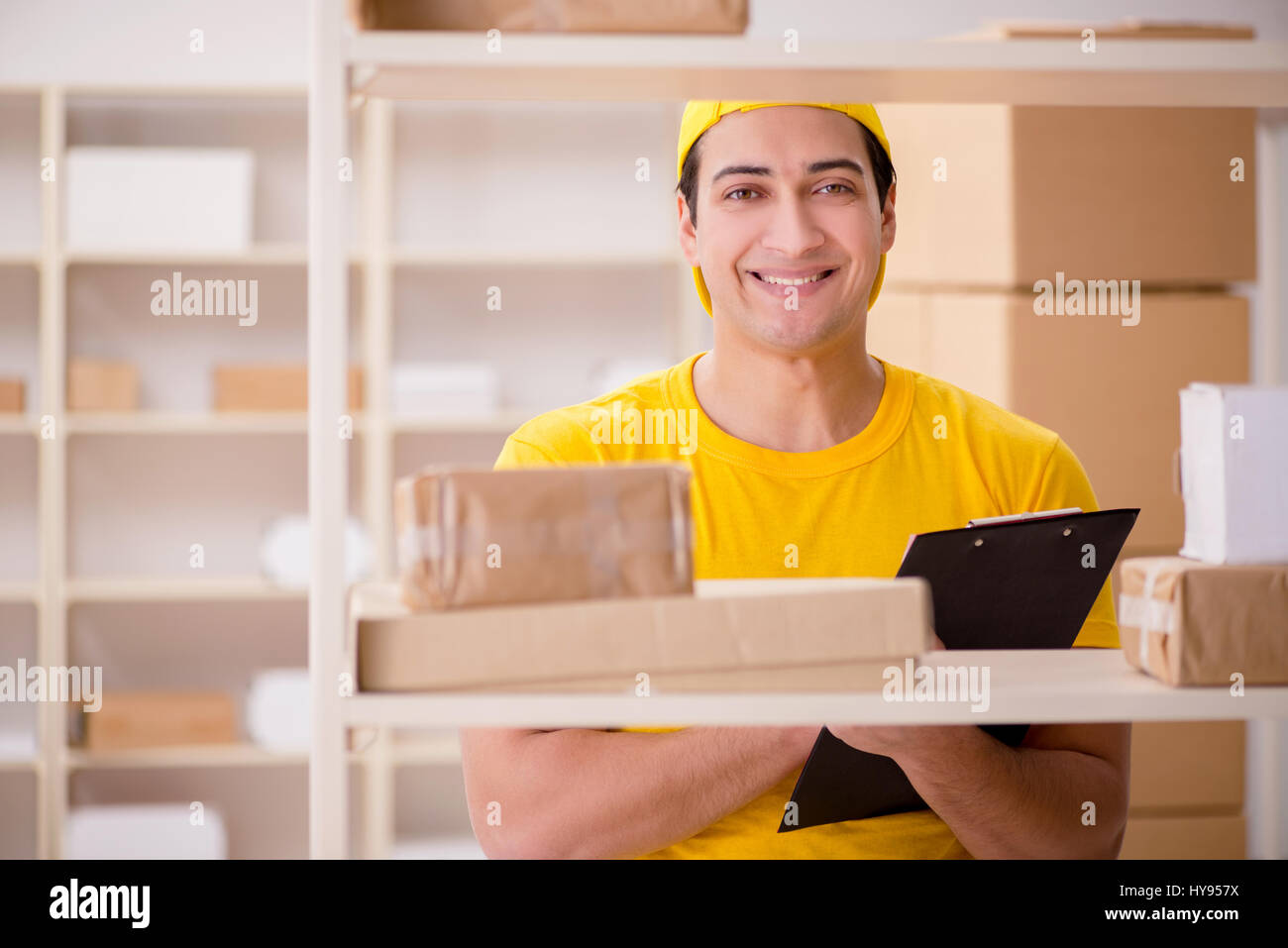 Man working in postal parcel delivery service office Stock Photo - Alamy