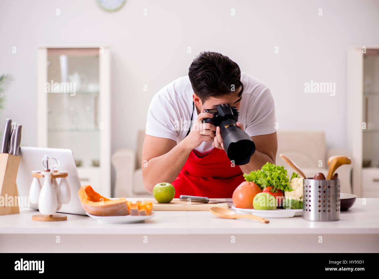 Food photographer taking photos in kitchen Stock Photo - Alamy