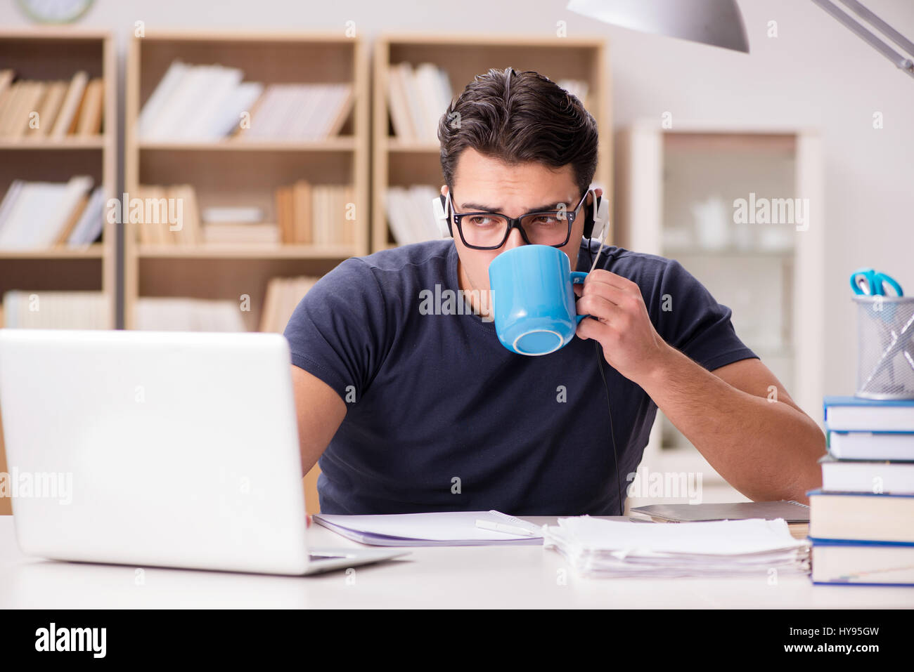 Young student drinking coffee from cup Stock Photo - Alamy