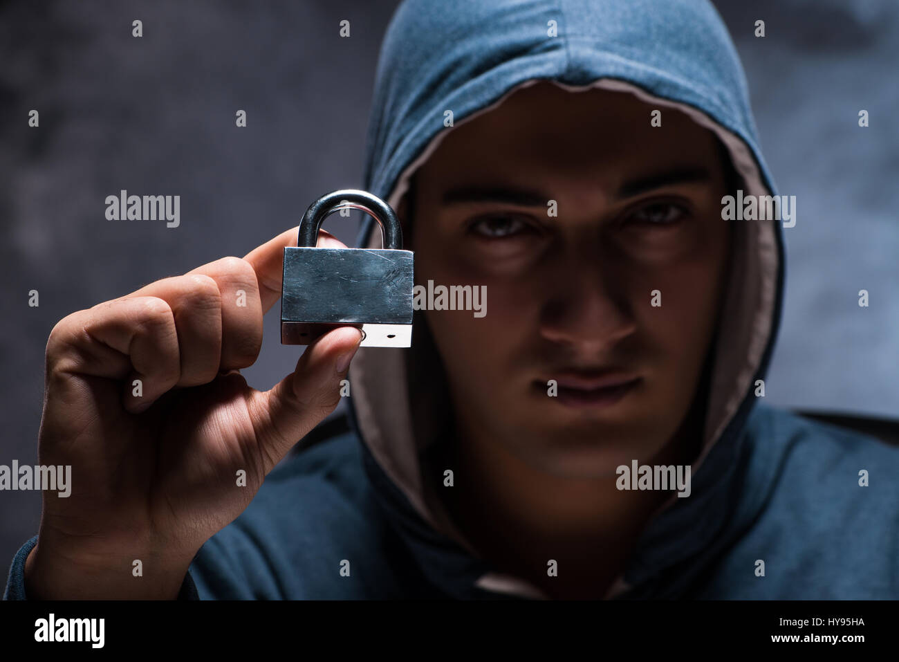 Computer hacker working in dark room Stock Photo - Alamy