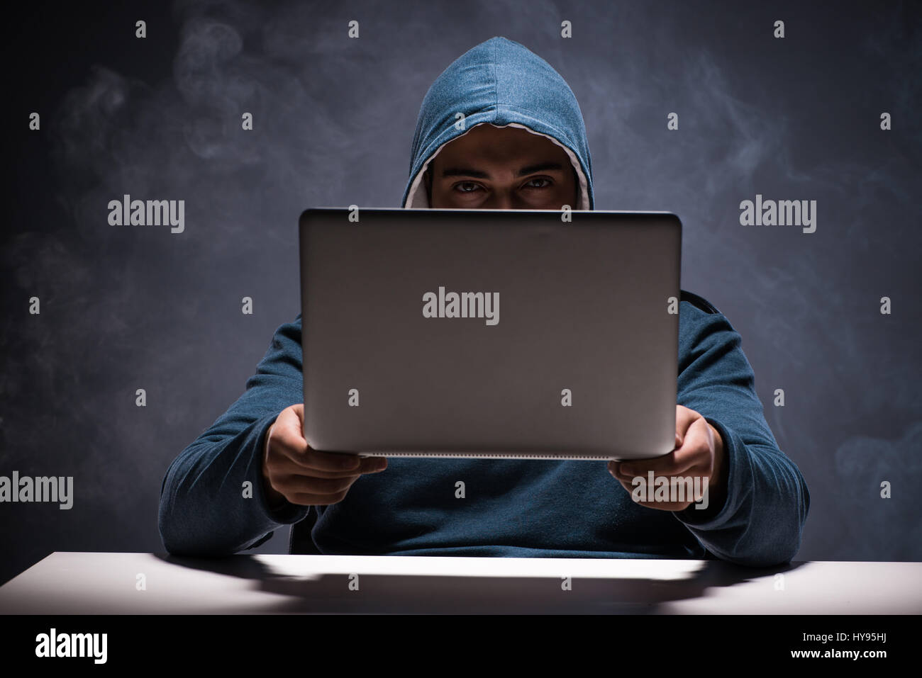 Computer hacker working in dark room Stock Photo - Alamy