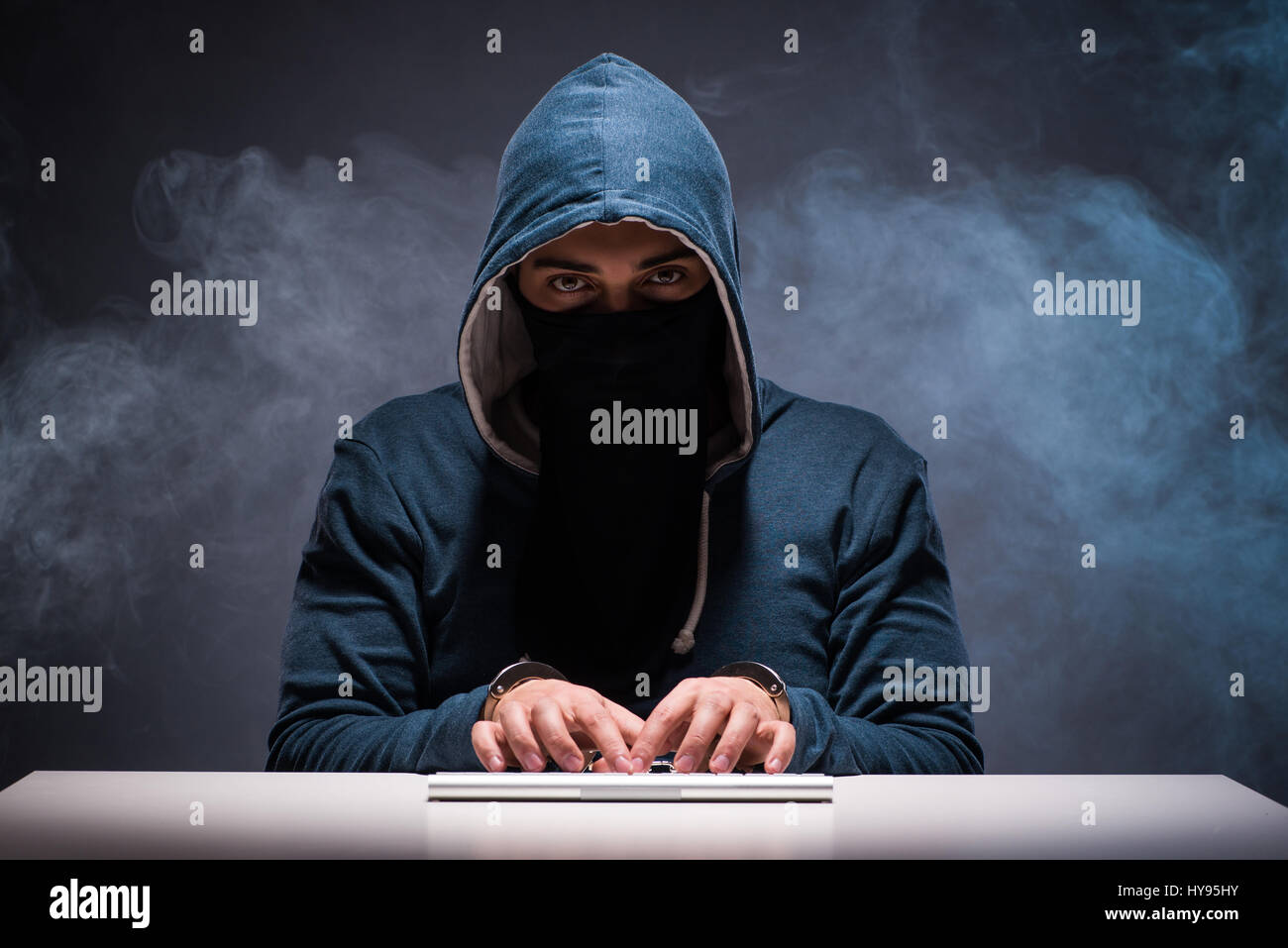 Computer hacker working in dark room Stock Photo - Alamy