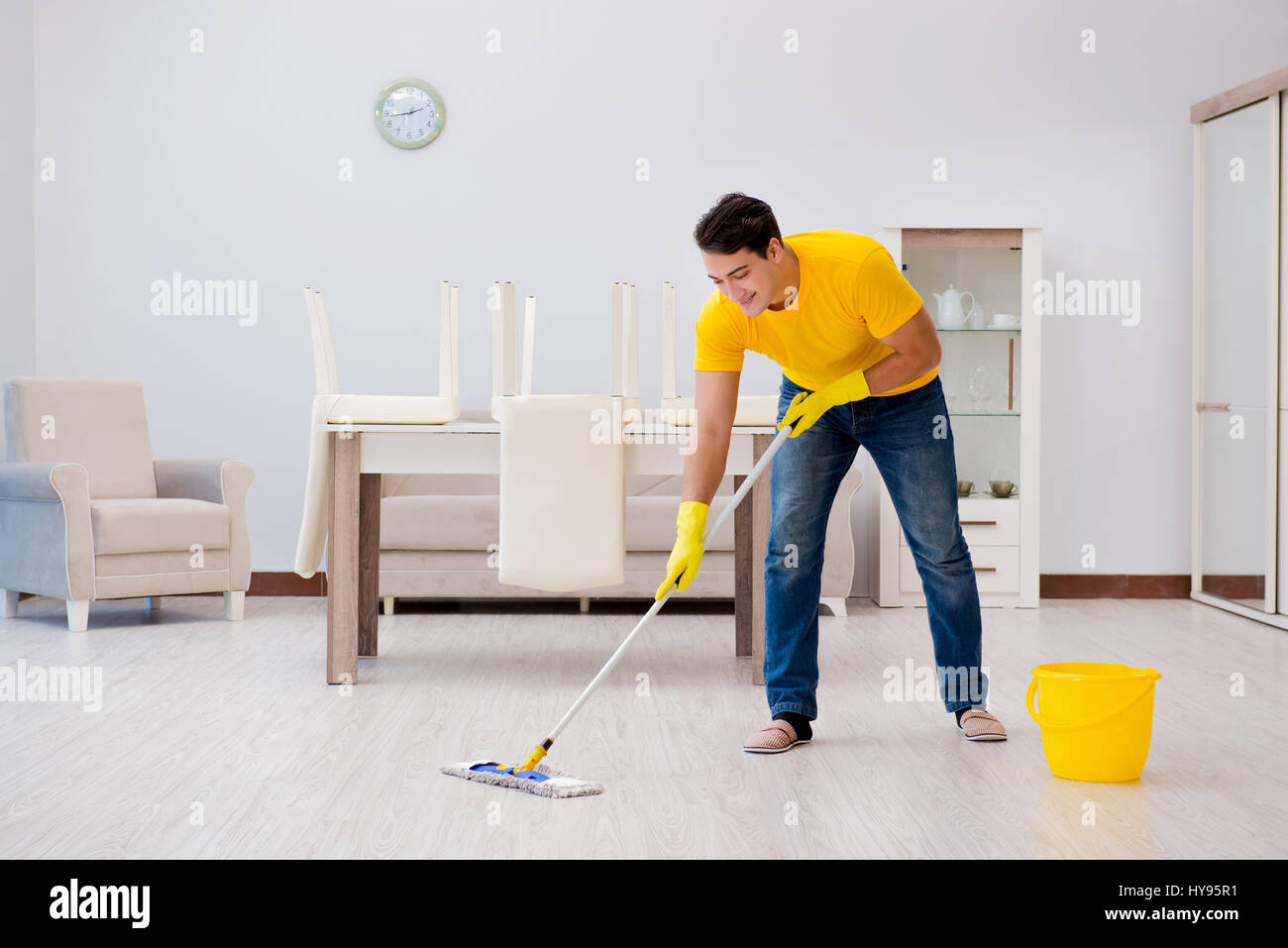 Man cleaning the house helping his wife Stock Photo - Alamy