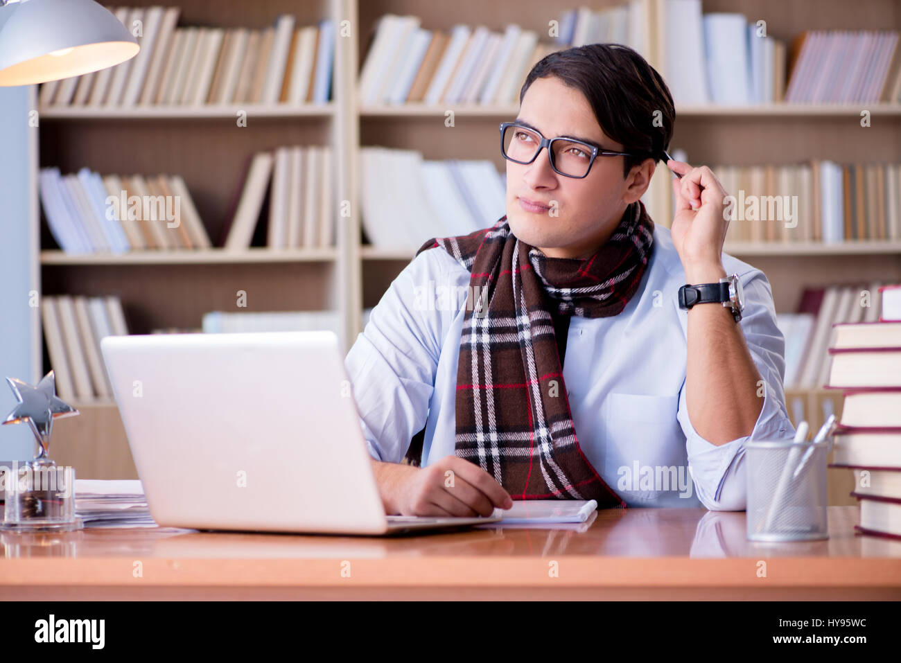 Young writer working in the library Stock Photo - Alamy