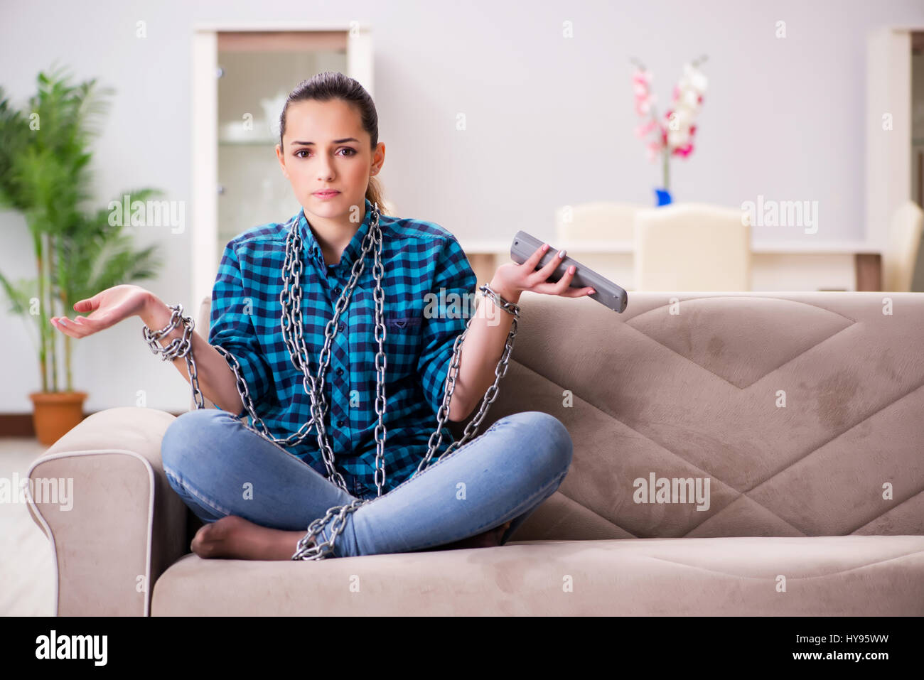 Young girl addicted to tv wasting her time Stock Photo - Alamy