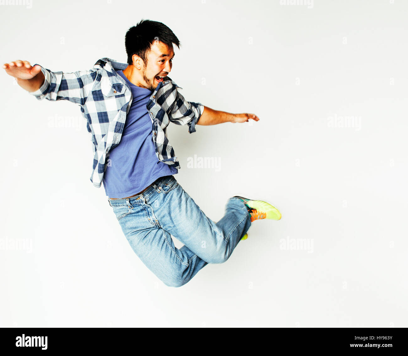 young pretty asian man jumping cheerful against white background Stock ...