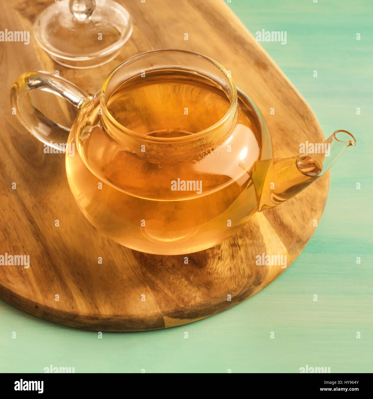 Teapot full of tea on teal texture with copyspace Stock Photo - Alamy