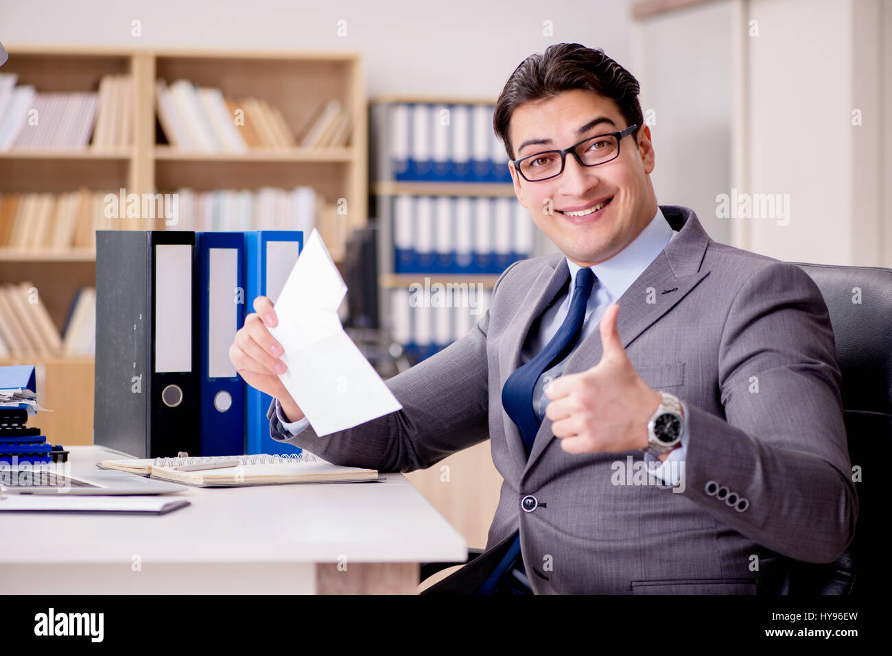Businessman receiving letter envelope in office Stock Photo - Alamy