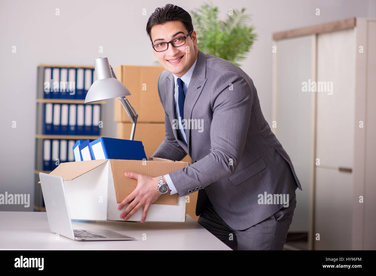 Young handsome businessman moving offices Stock Photo - Alamy