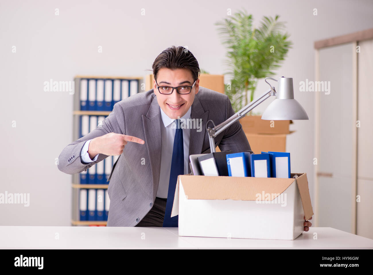 Young handsome businessman moving offices Stock Photo - Alamy