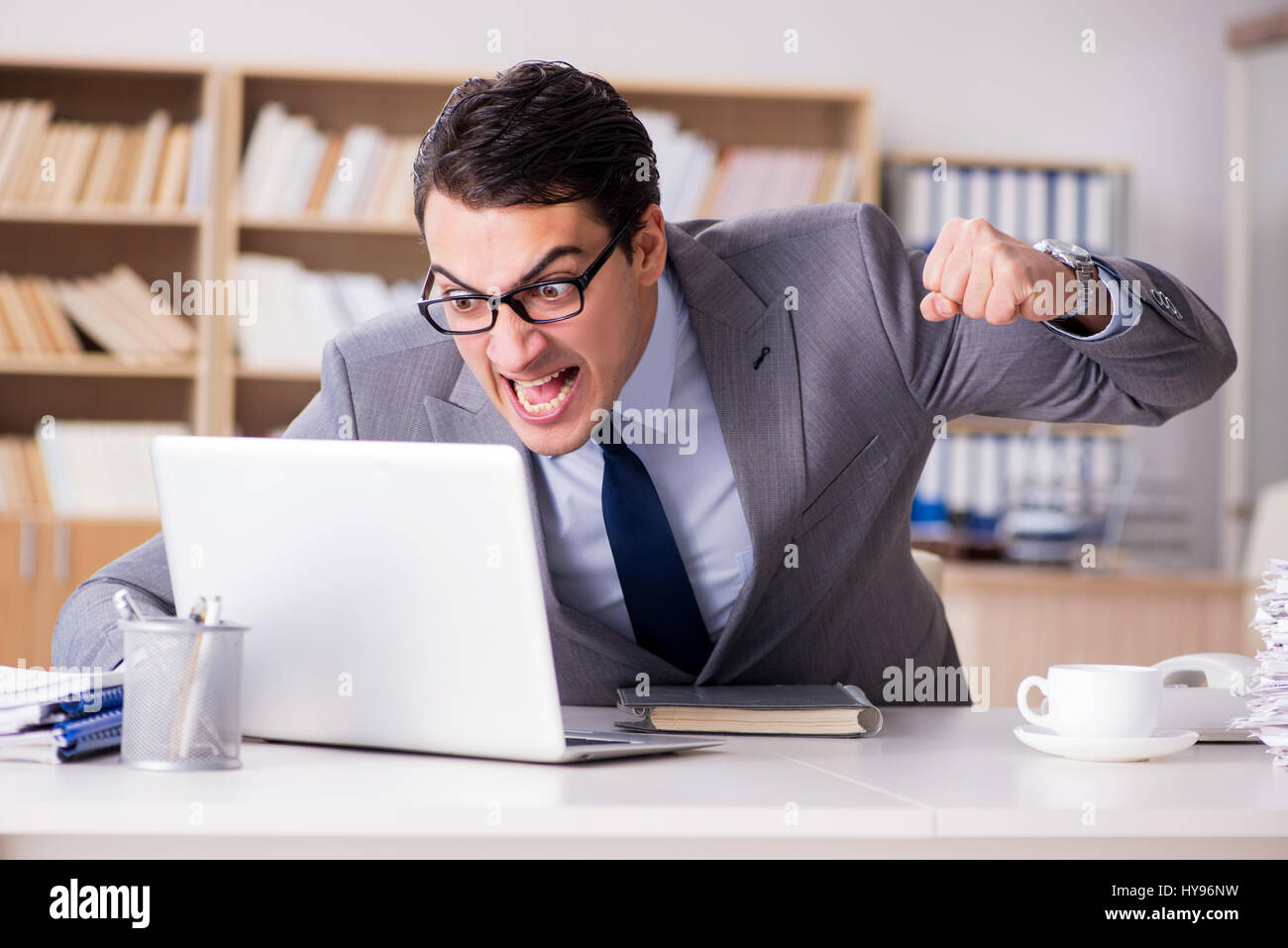 Angry businessman working in the office Stock Photo - Alamy